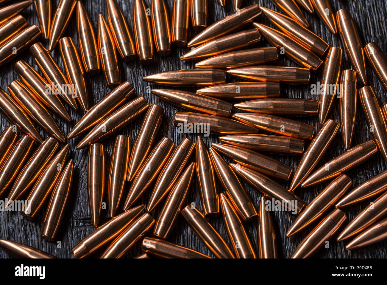 Placer copper bullets on a dark wooden background Stock Photo - Alamy