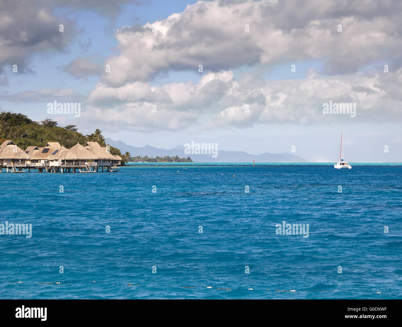 seacoast with palm trees and small houses on water Stock Photo - Alamy