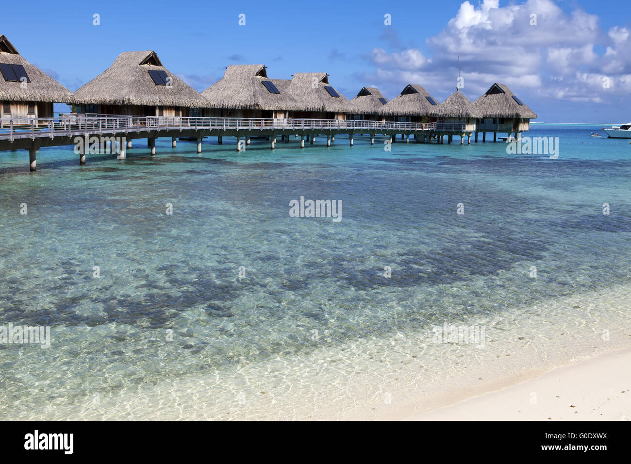 Polynesian landscape -small houses on water Stock Photo - Alamy