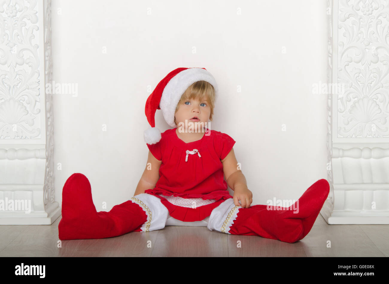 girl in costume of Santa Claus sitting on floor Stock Photo - Alamy