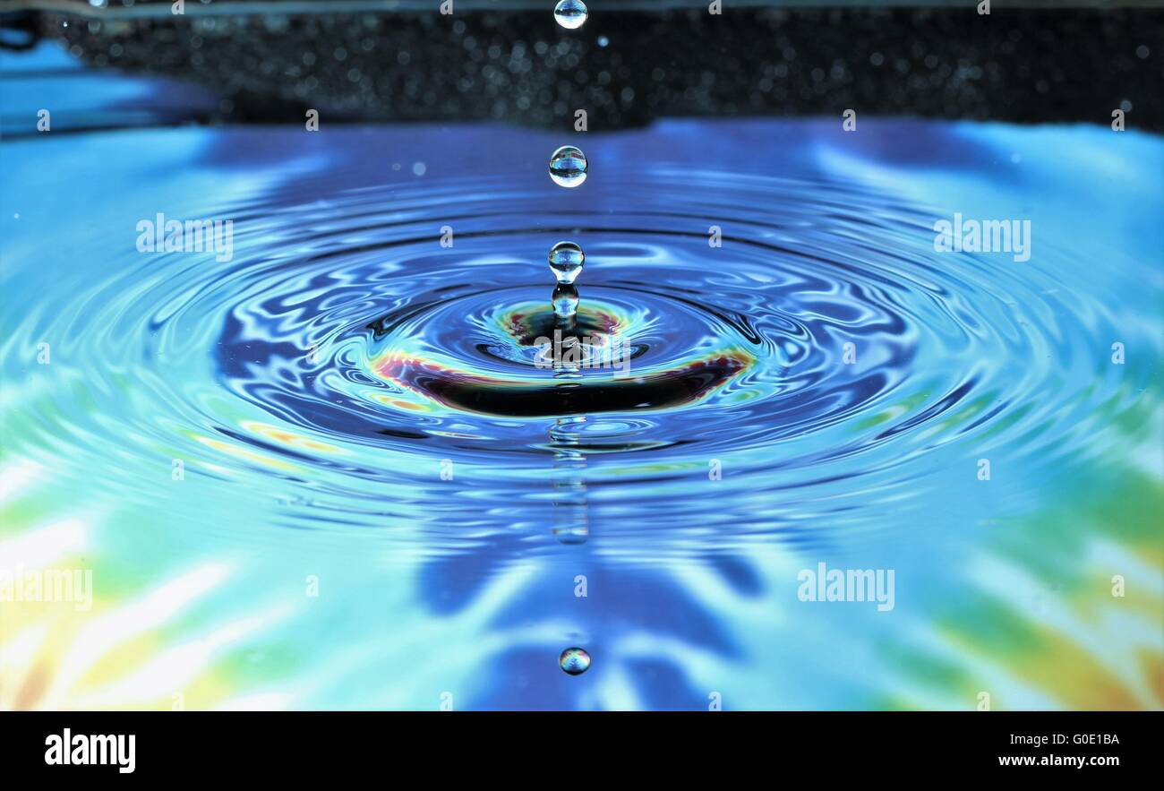 Bouncing drops with reflection and ripples in water hi-res stock ...
