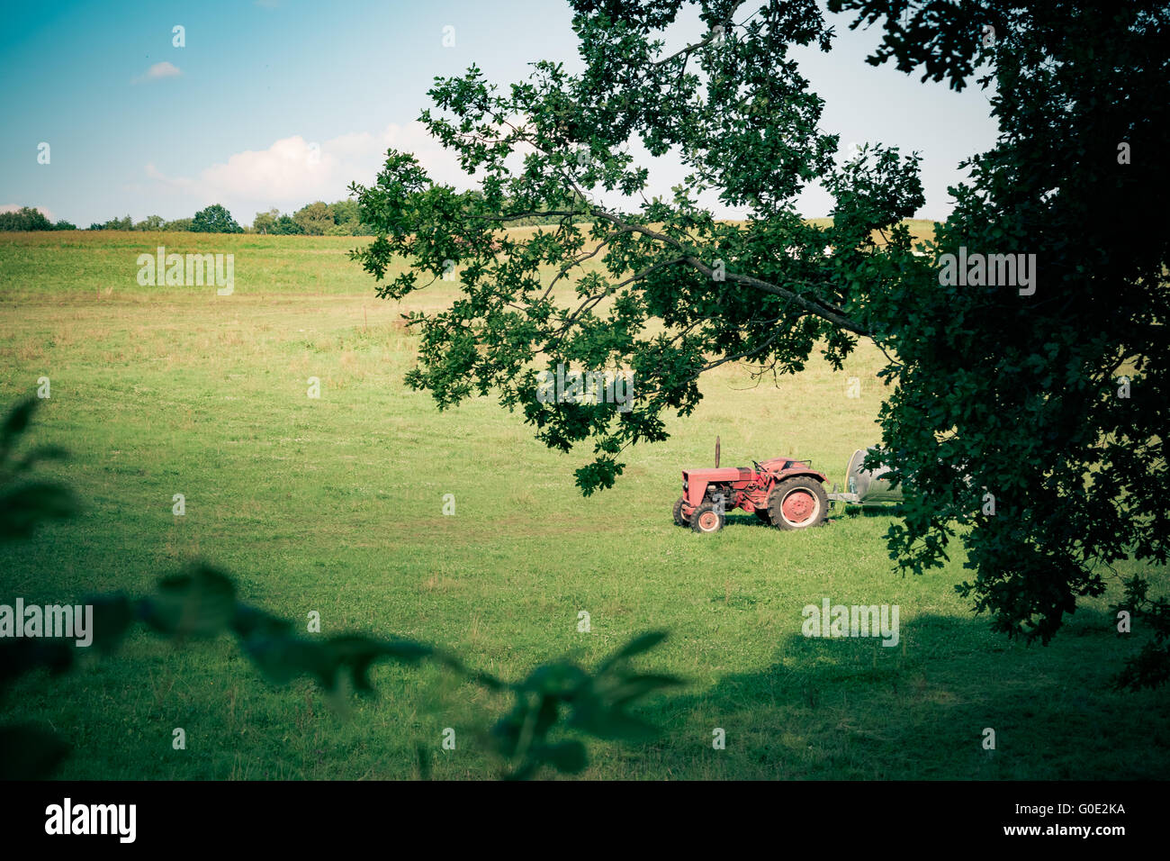 Red Tractor on a field Stock Photo - Alamy