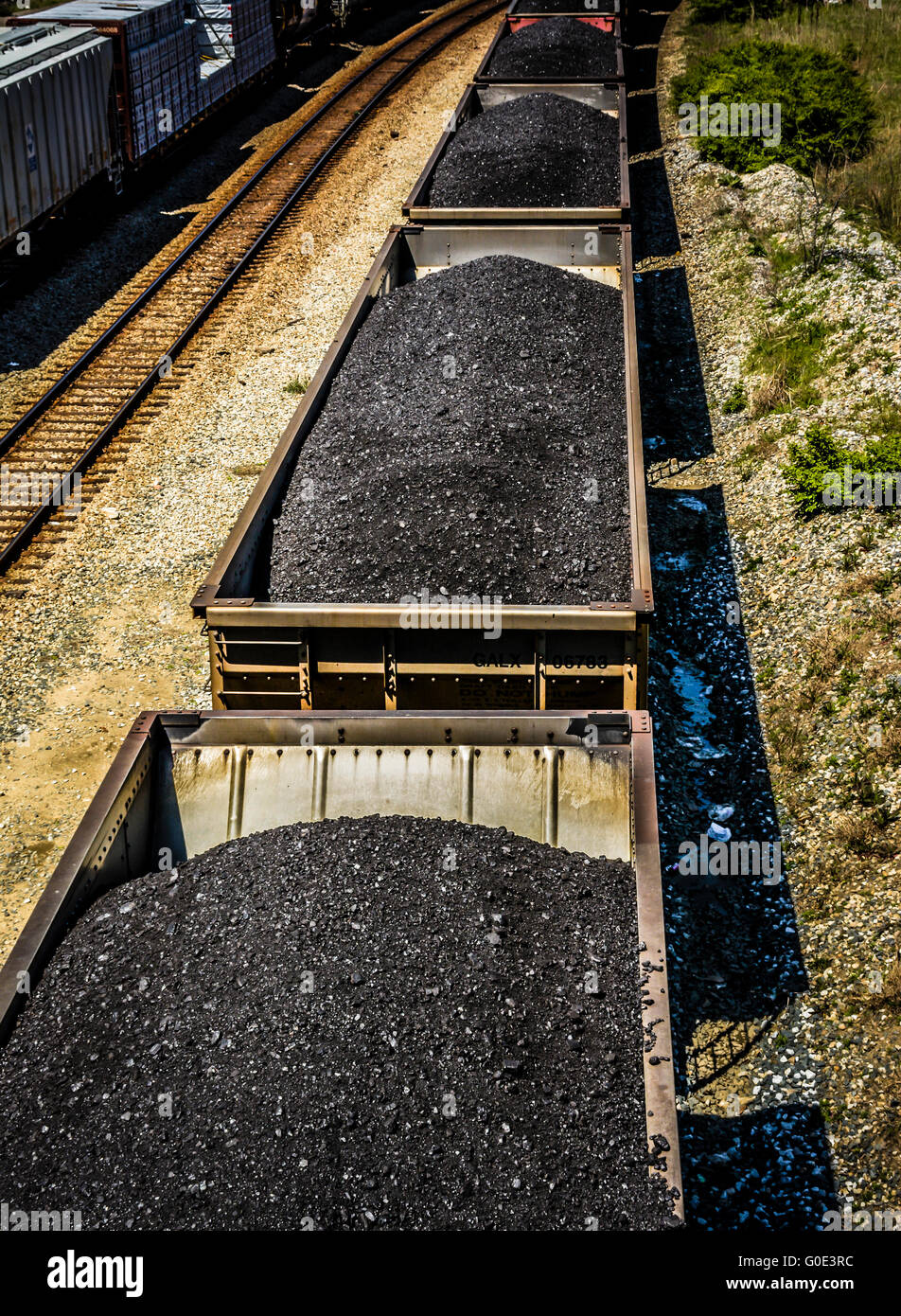 Overhead view of train cars piled high with black coal on railroad ...