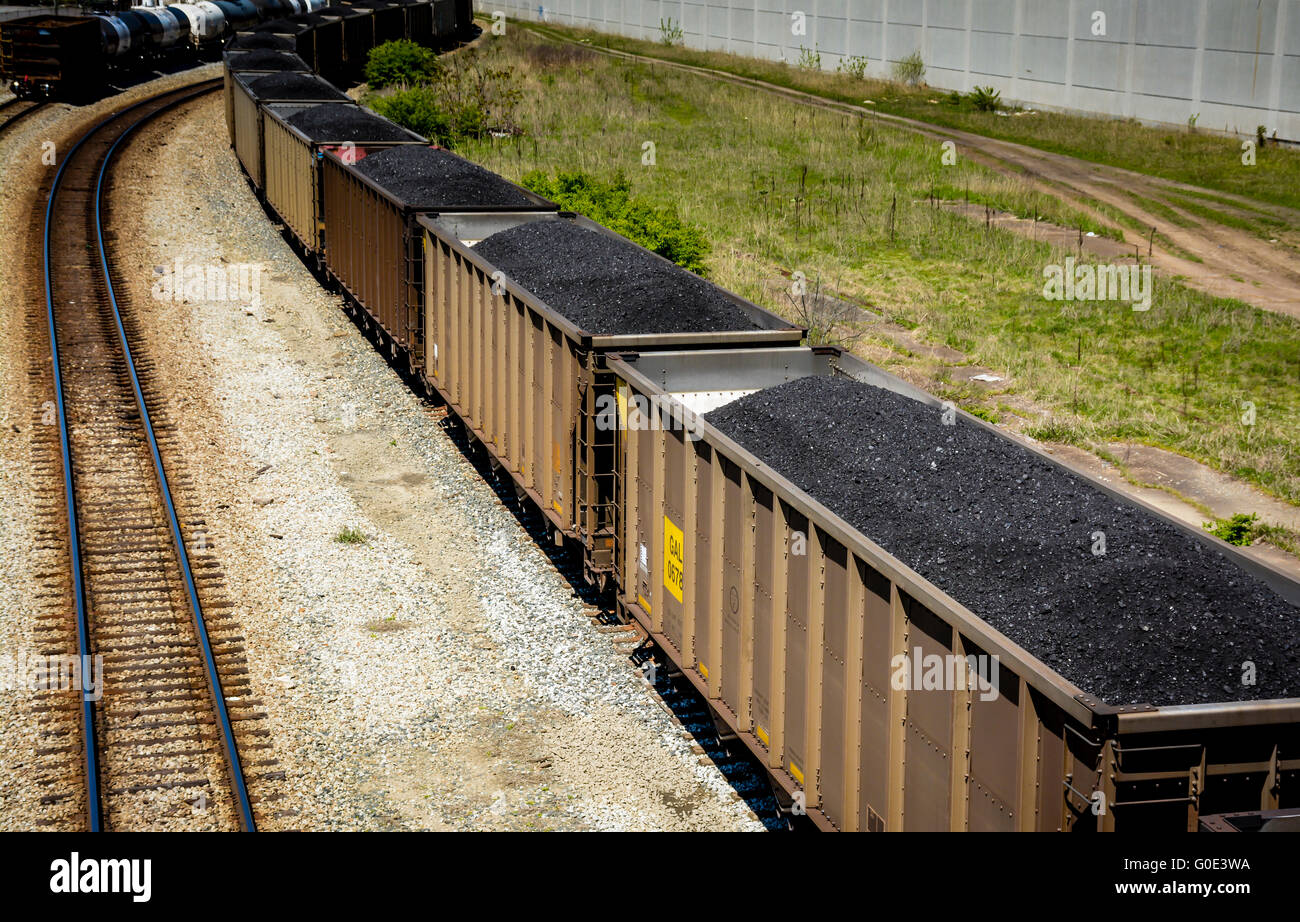 Overhead view of train cars piled high with black coal on railroad ...