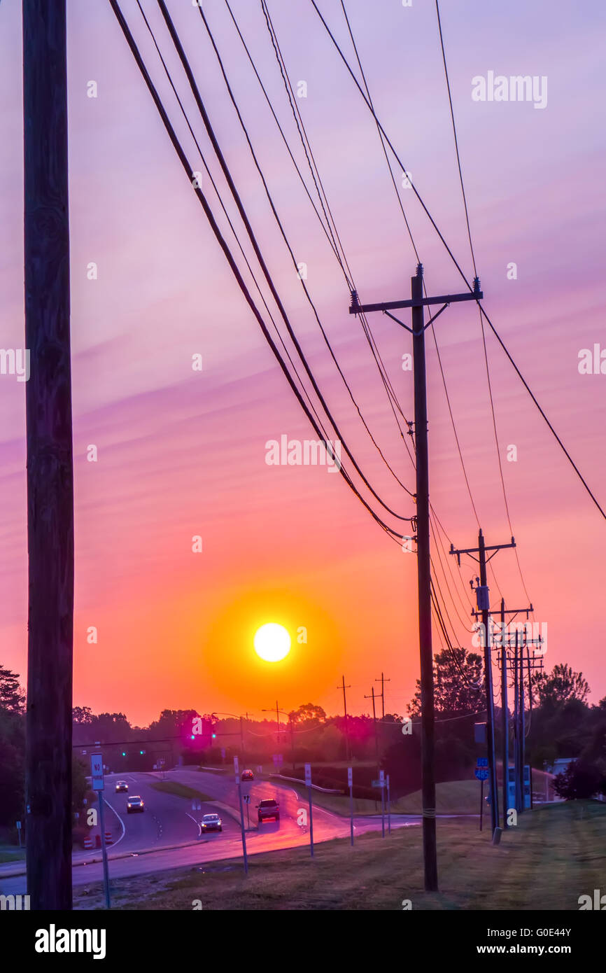 silhouetted electric pylon with power line at sunset Stock Photo - Alamy