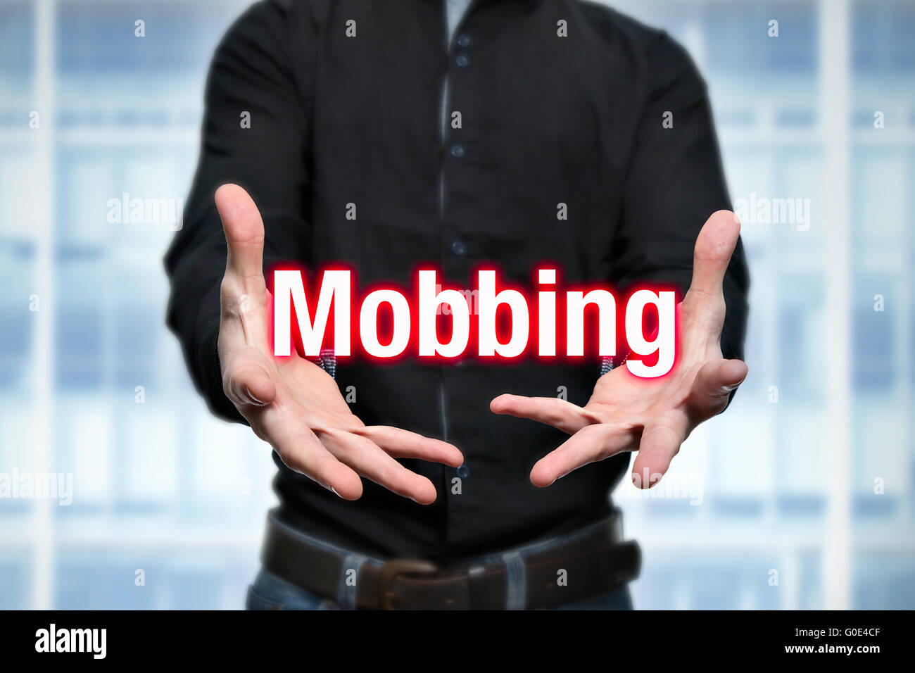 Mobbing, bullying, man holds lettering in the hands Stock Photo - Alamy
