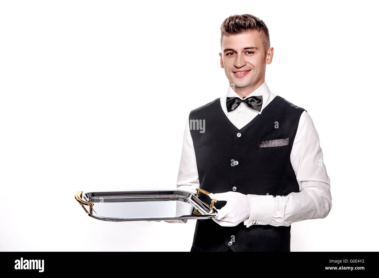 Portrait of young happy smiling waiter with on tray isolated on white ...