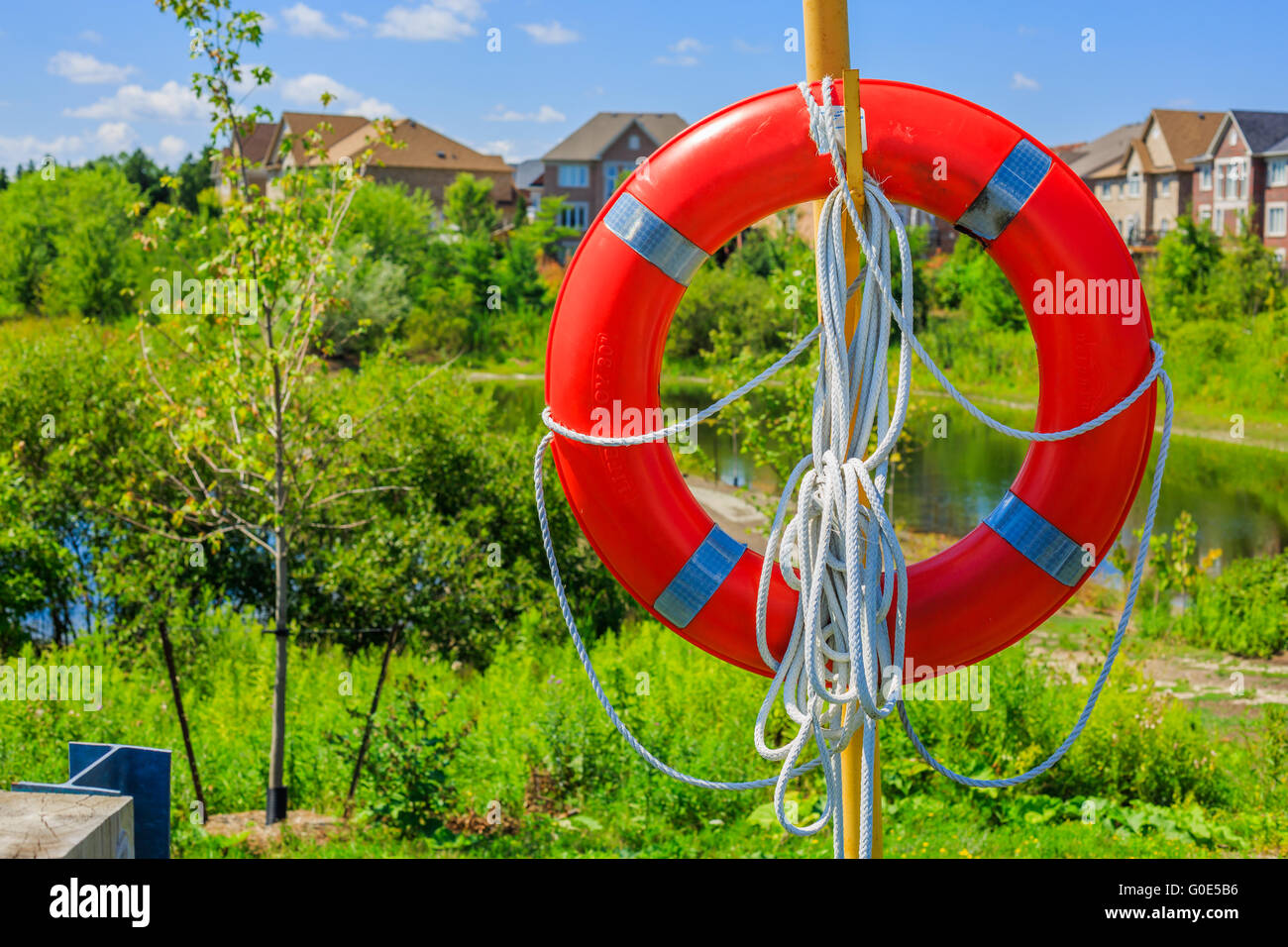 Lifebuoy on a background of luxury houses Stock Photo - Alamy