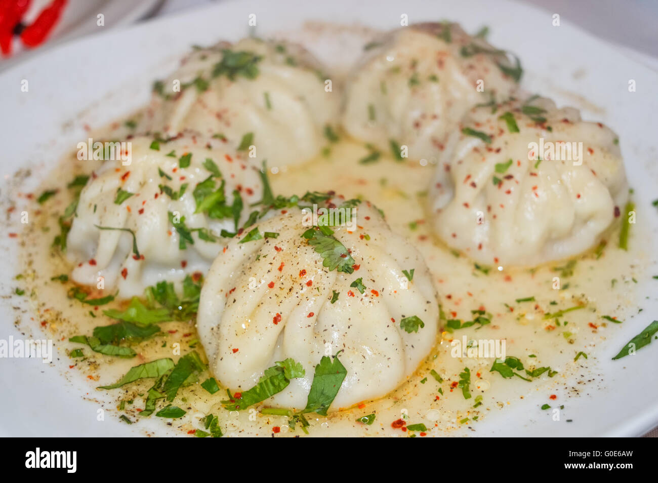 Hinkali with meat on white plate Stock Photo - Alamy