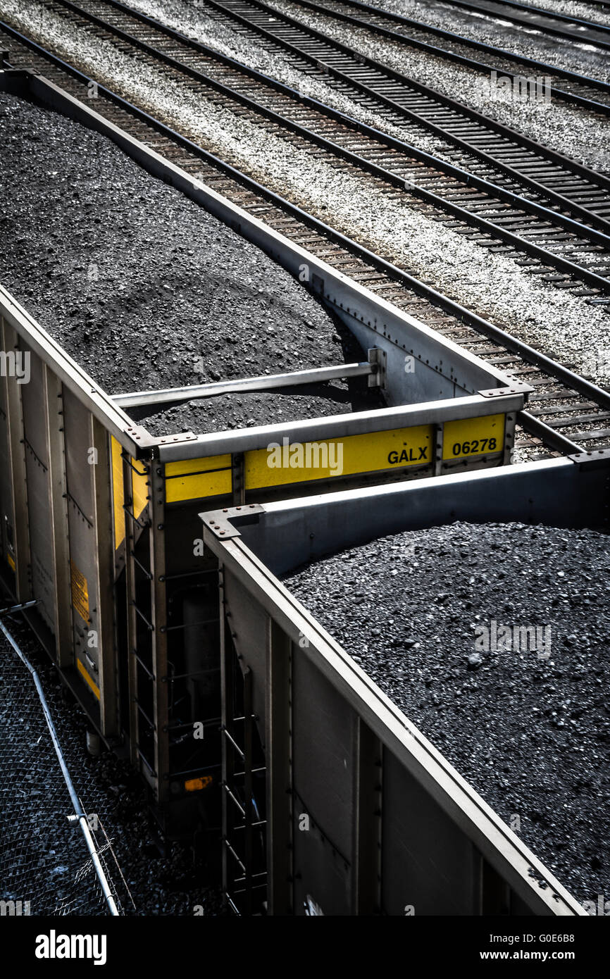 Overhead view of train cars piled high with black coal on railroad ...