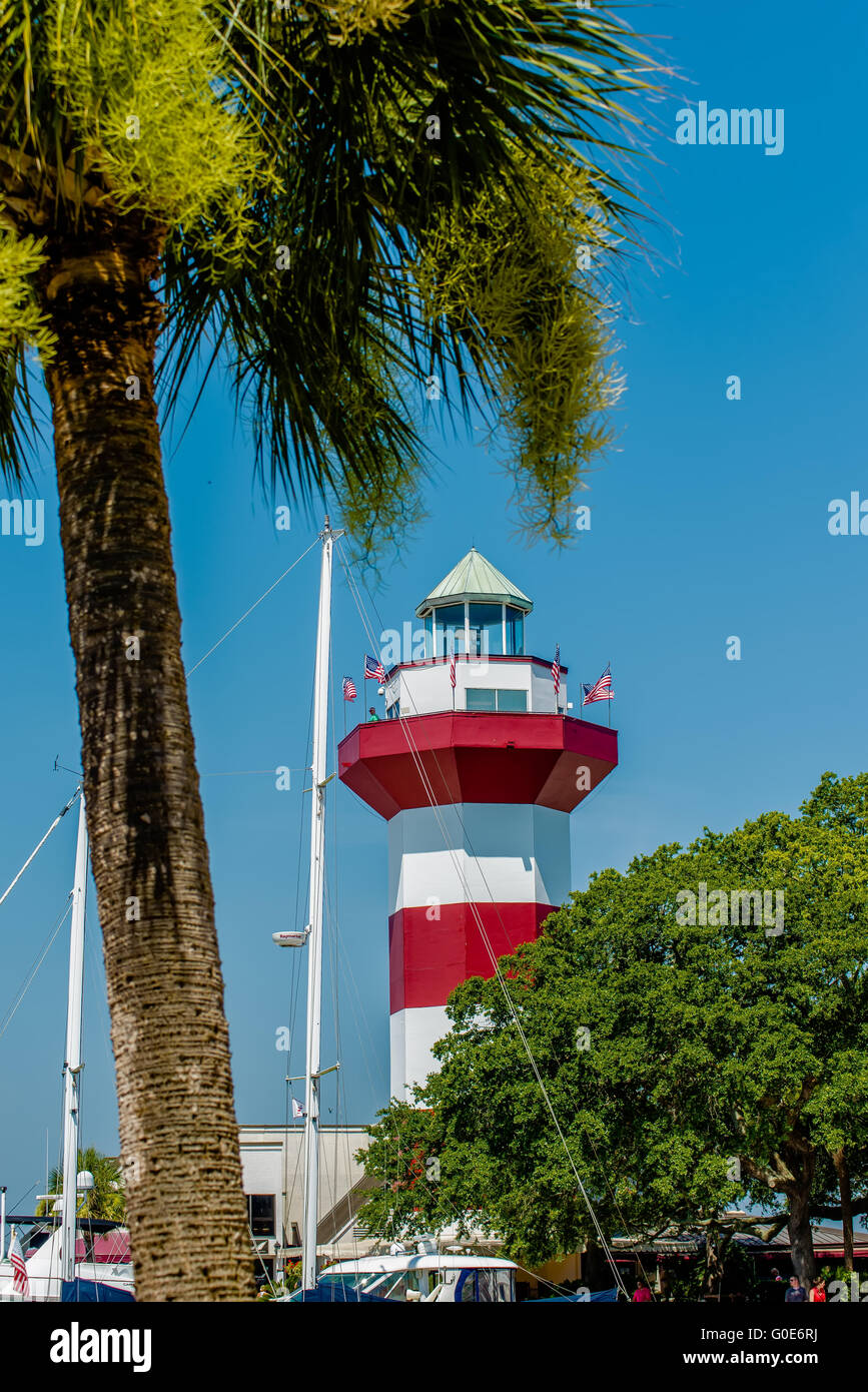 A clear blue sky features the Harbour Town Lighthouse - famous landmark ...