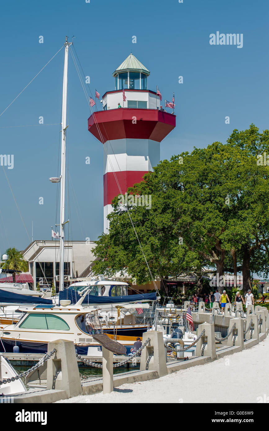 A clear blue sky features the Harbour Town Lighthouse - famous landmark ...