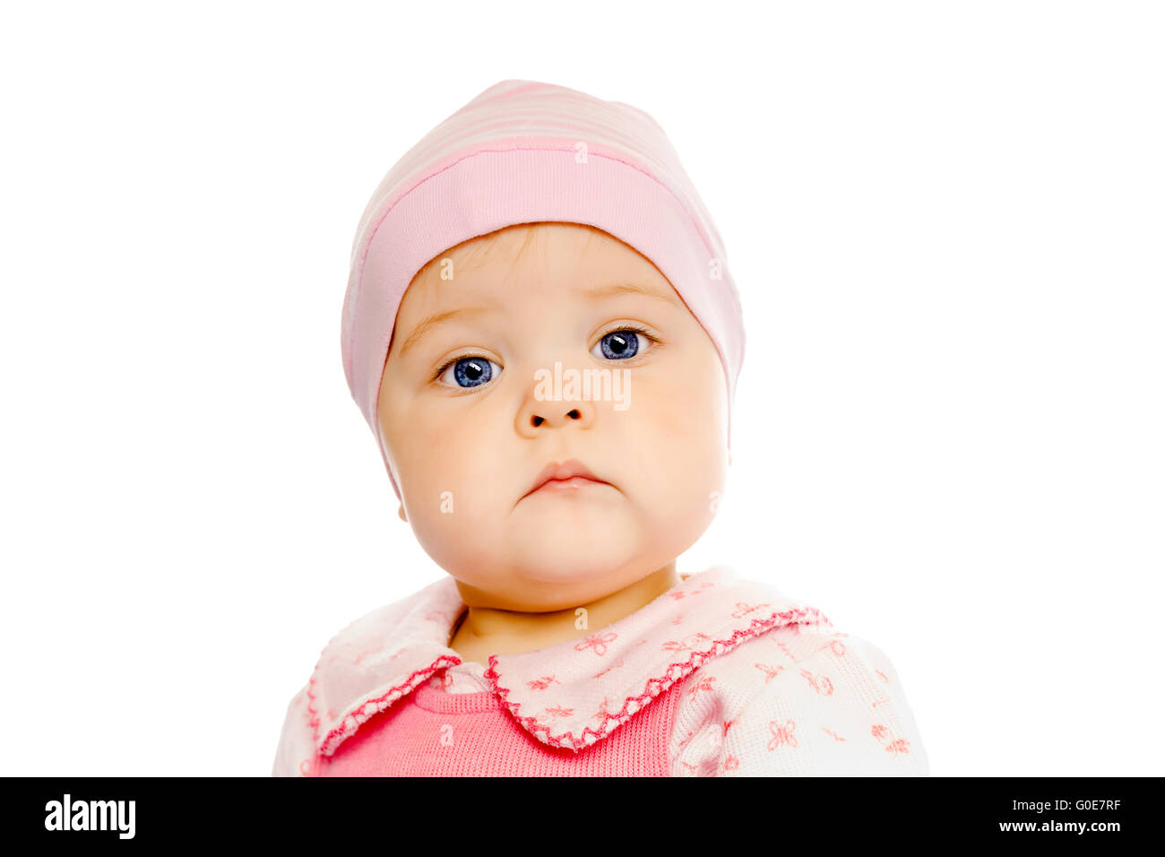 serious baby in a pink hat on a white background Stock Photo - Alamy
