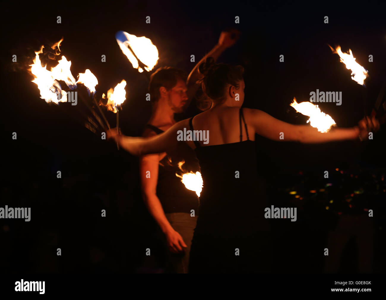 Male and female fire dancers twirling fiery batons Stock Photo - Alamy