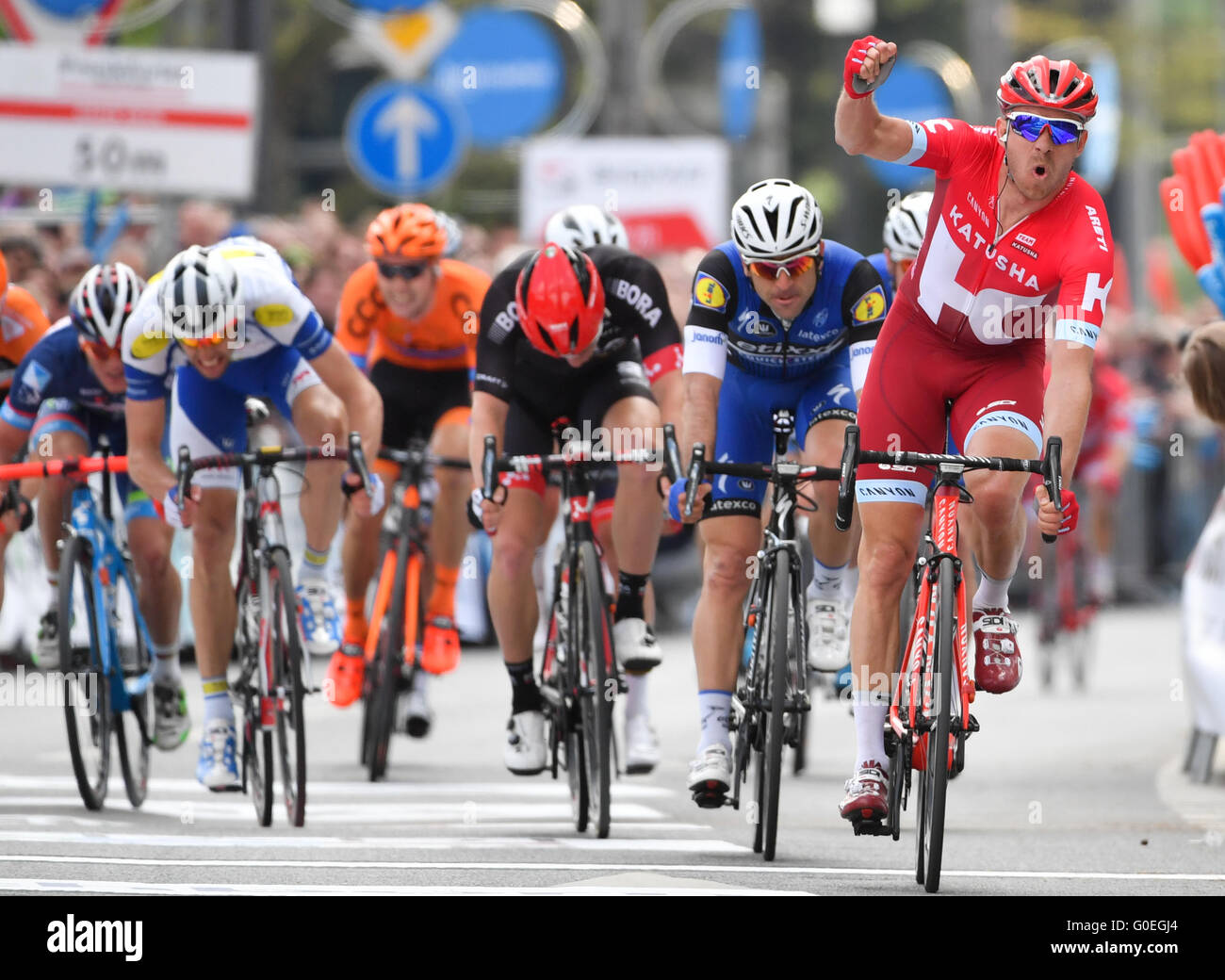 Winner Alexander Kristoff (R) of Team Katusha celebrates at the finish ...