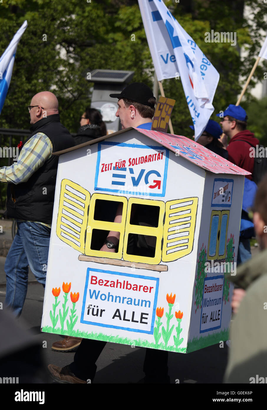 Marcher in the Berlin May Day parade 2016; he is dressed as a house ...