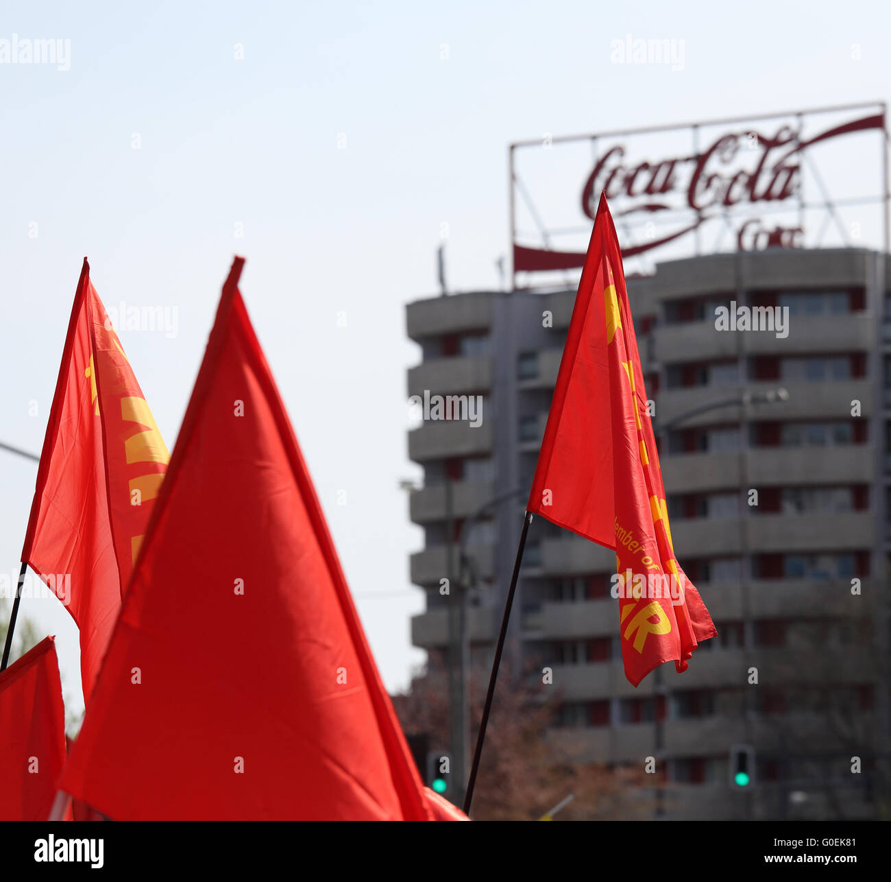 Red flags with the Coca Cola sign on top of a building in the ...