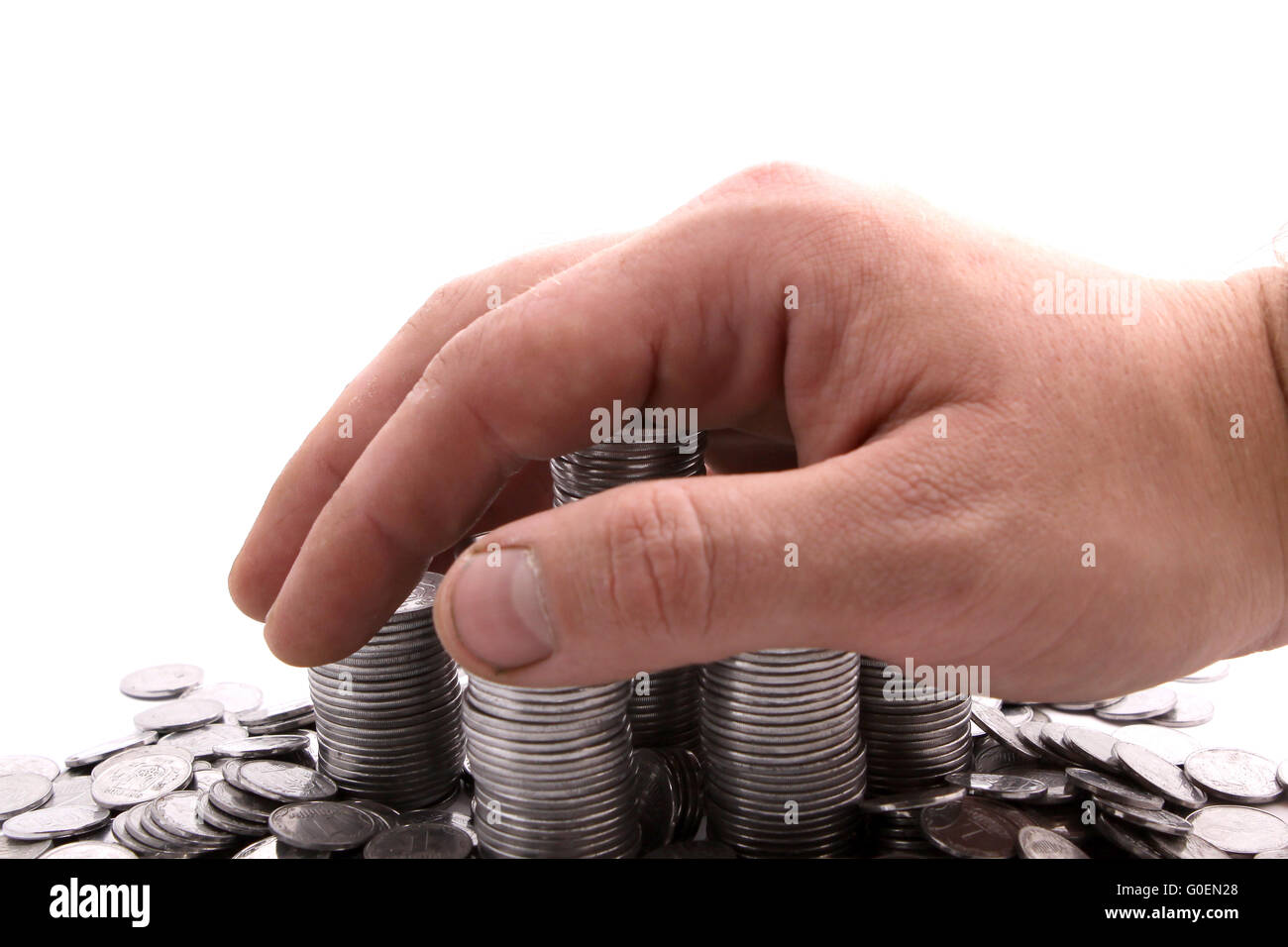 Hand adding coins Stock Photo - Alamy
