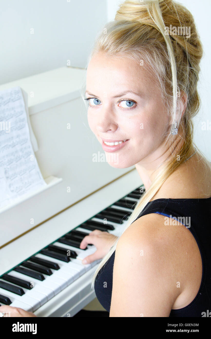 Woman playing a musical instrument hi-res stock photography and images ...