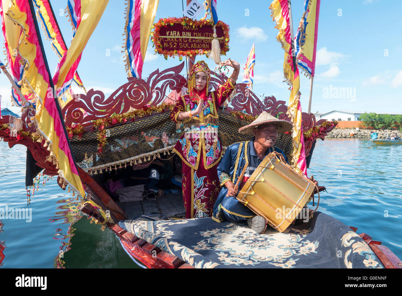 Bajau lady dancing on traditional boat called Lepa Lepa decorated with ...