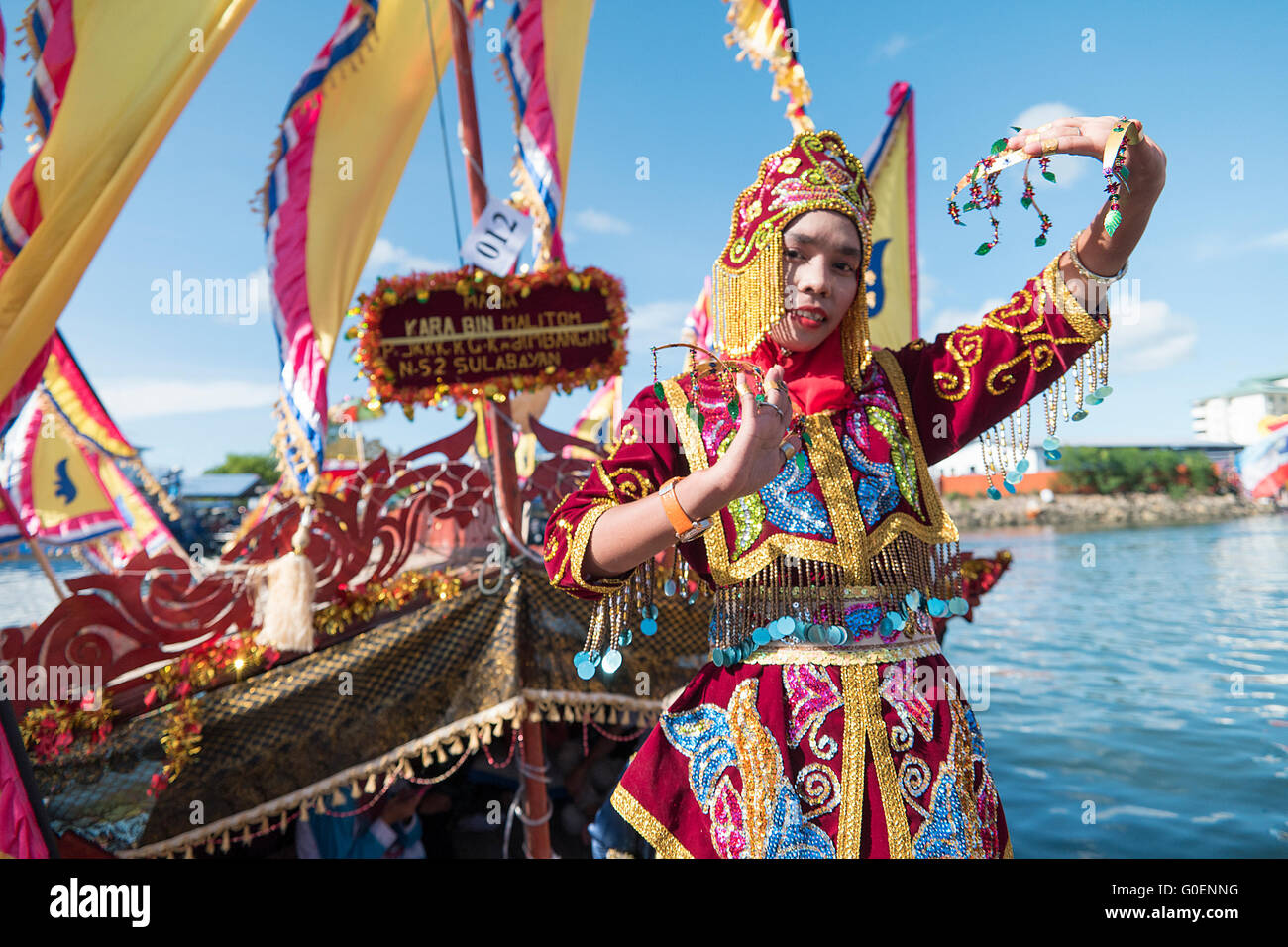 Bajau lady dancing on traditional boat called Lepa Lepa decorated with ...