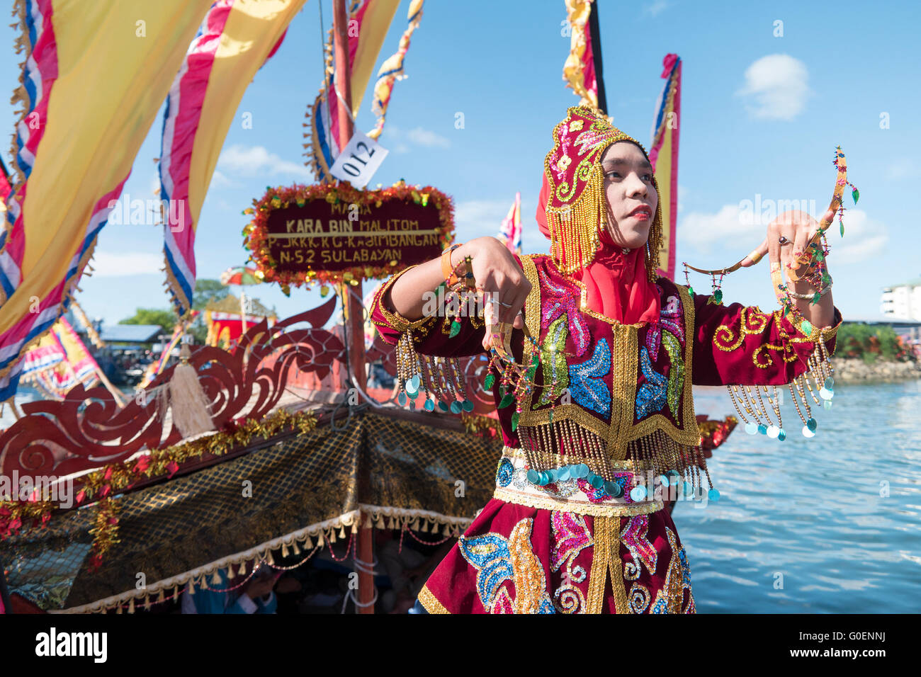 Bajau lady dancing on traditional boat called Lepa Lepa decorated with ...