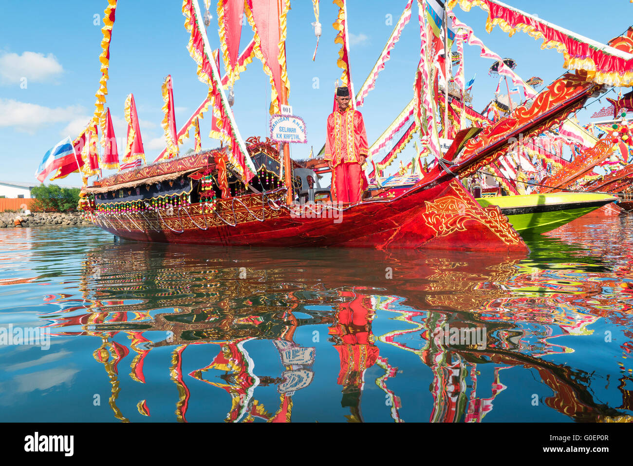 Bajau ethnic standing on his traditional boat called Lepa decorated ...