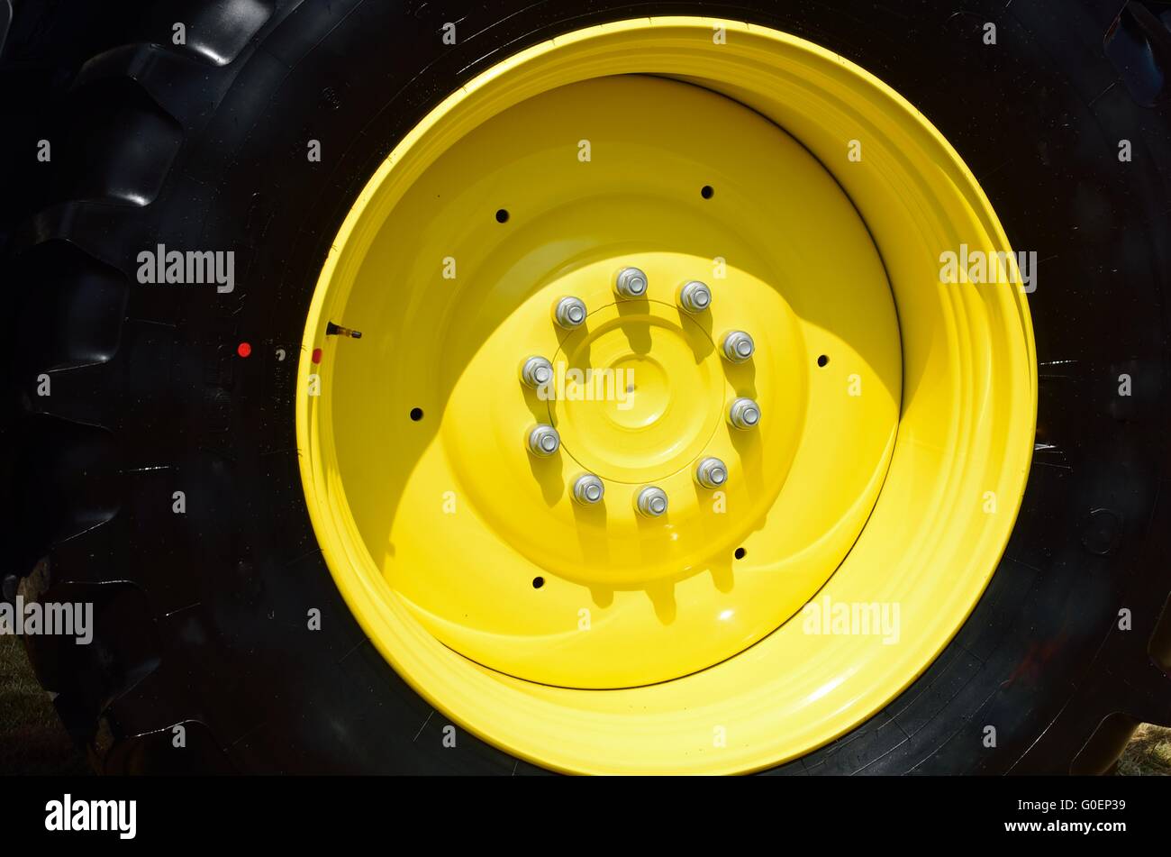 Black and Yellow tractor wheel Stock Photo - Alamy