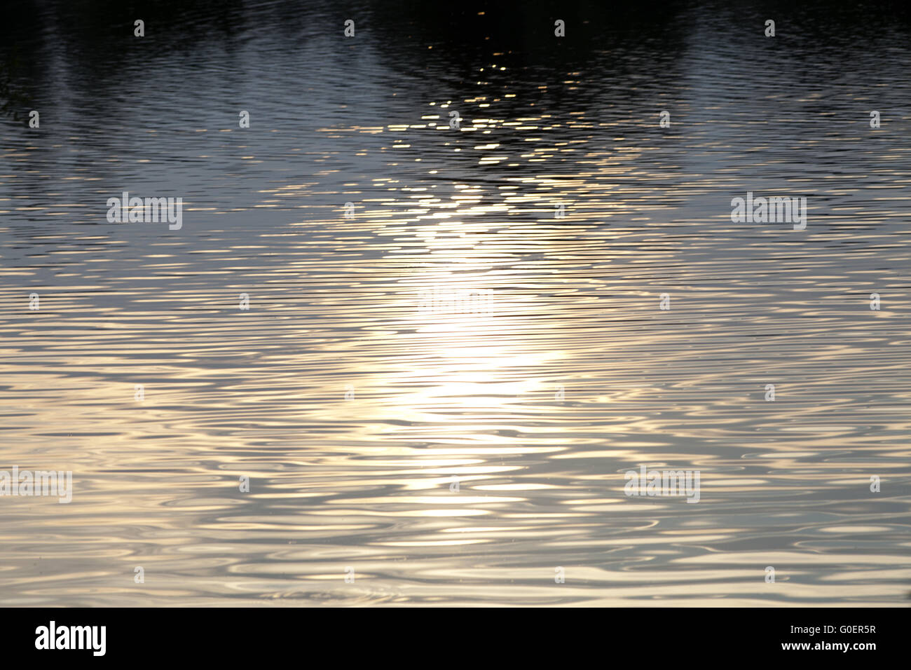 Sparkling water with lights of sunset Stock Photo - Alamy