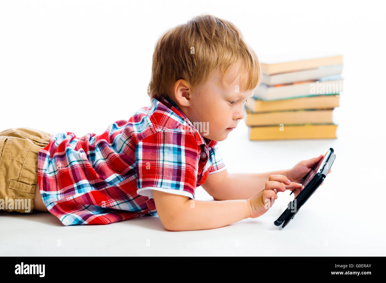 small boy with tablet computer lying on the floor Stock Photo - Alamy