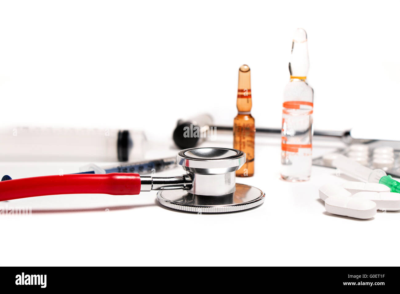 Tablets and a syringe Stock Photo - Alamy