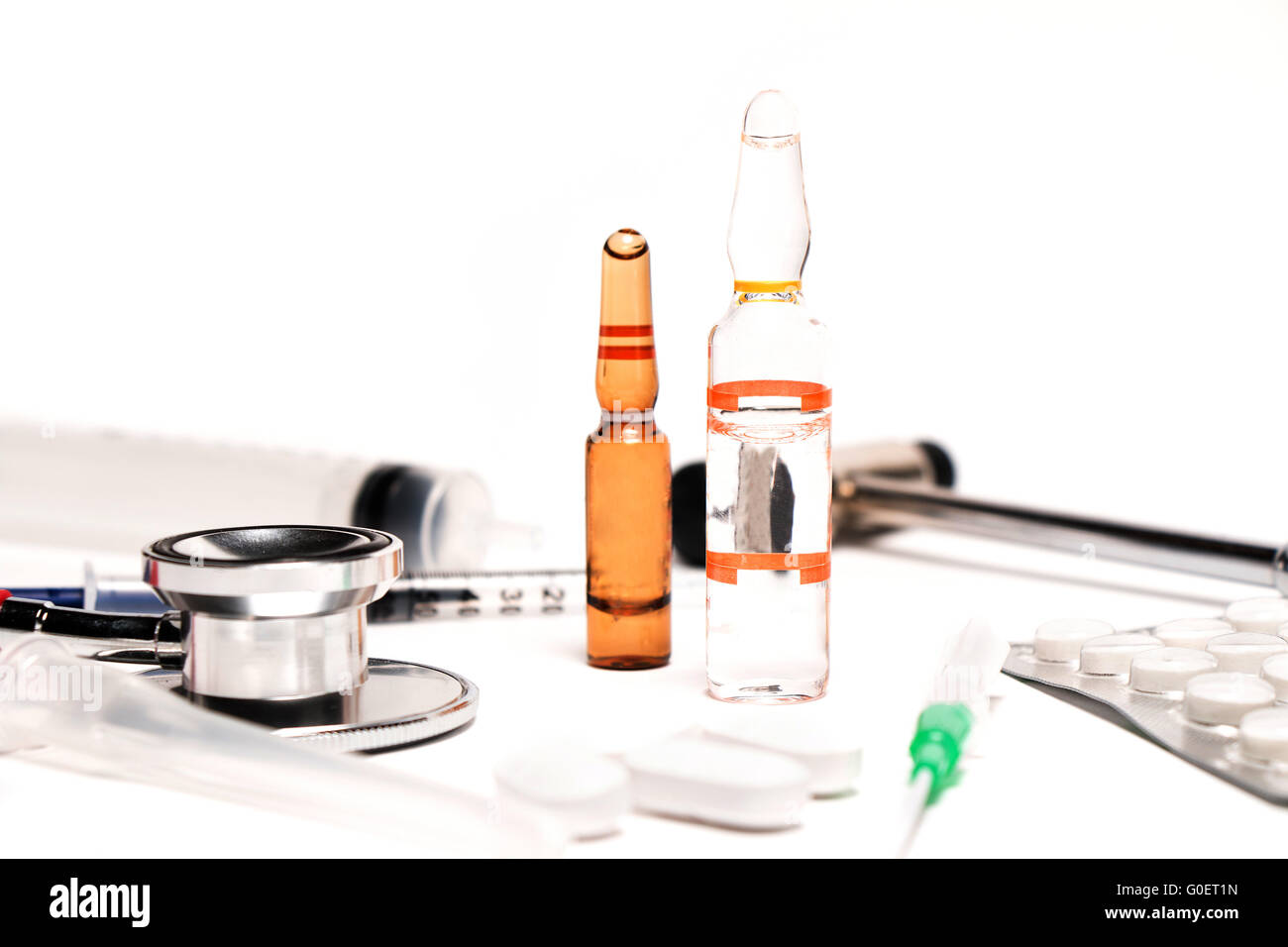 Tablets and a syringe Stock Photo - Alamy