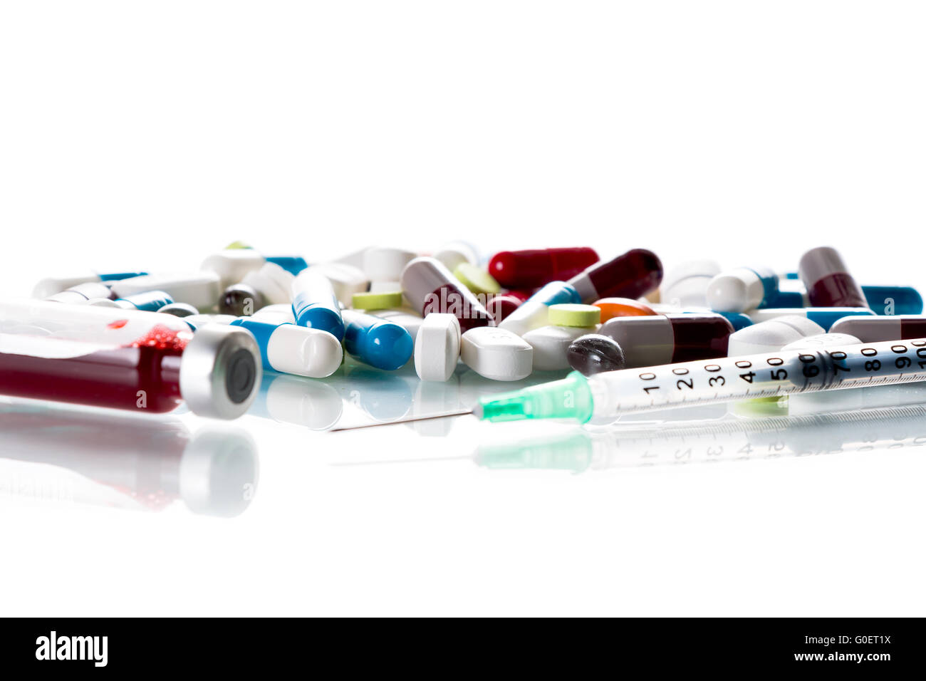 Tablets and a syringe Stock Photo - Alamy