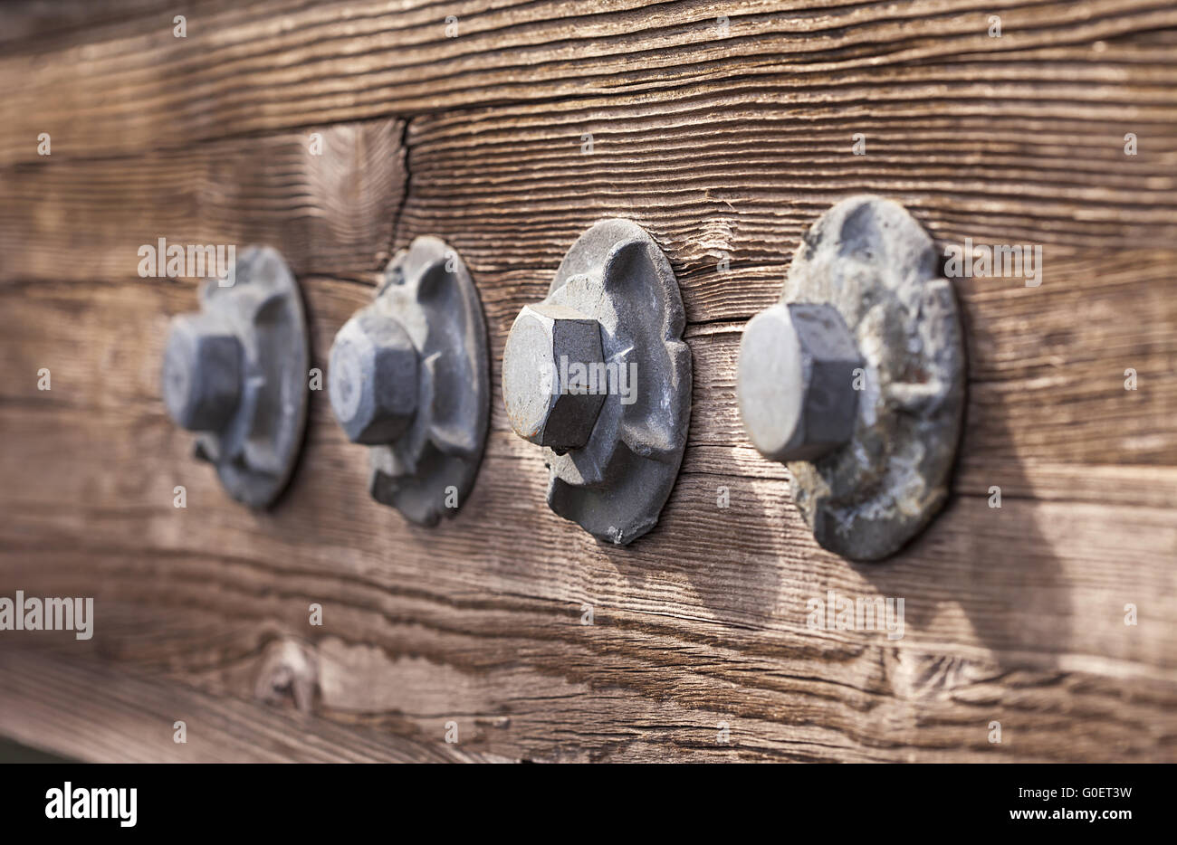 Bolts down length of wooden bridge handrail Stock Photo - Alamy