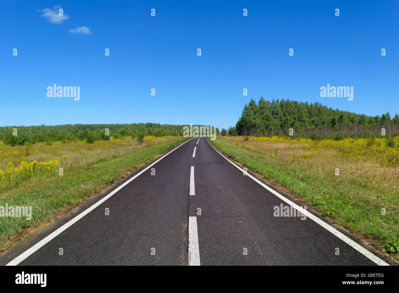 Road with dashed and solid white road markings Stock Photo - Alamy