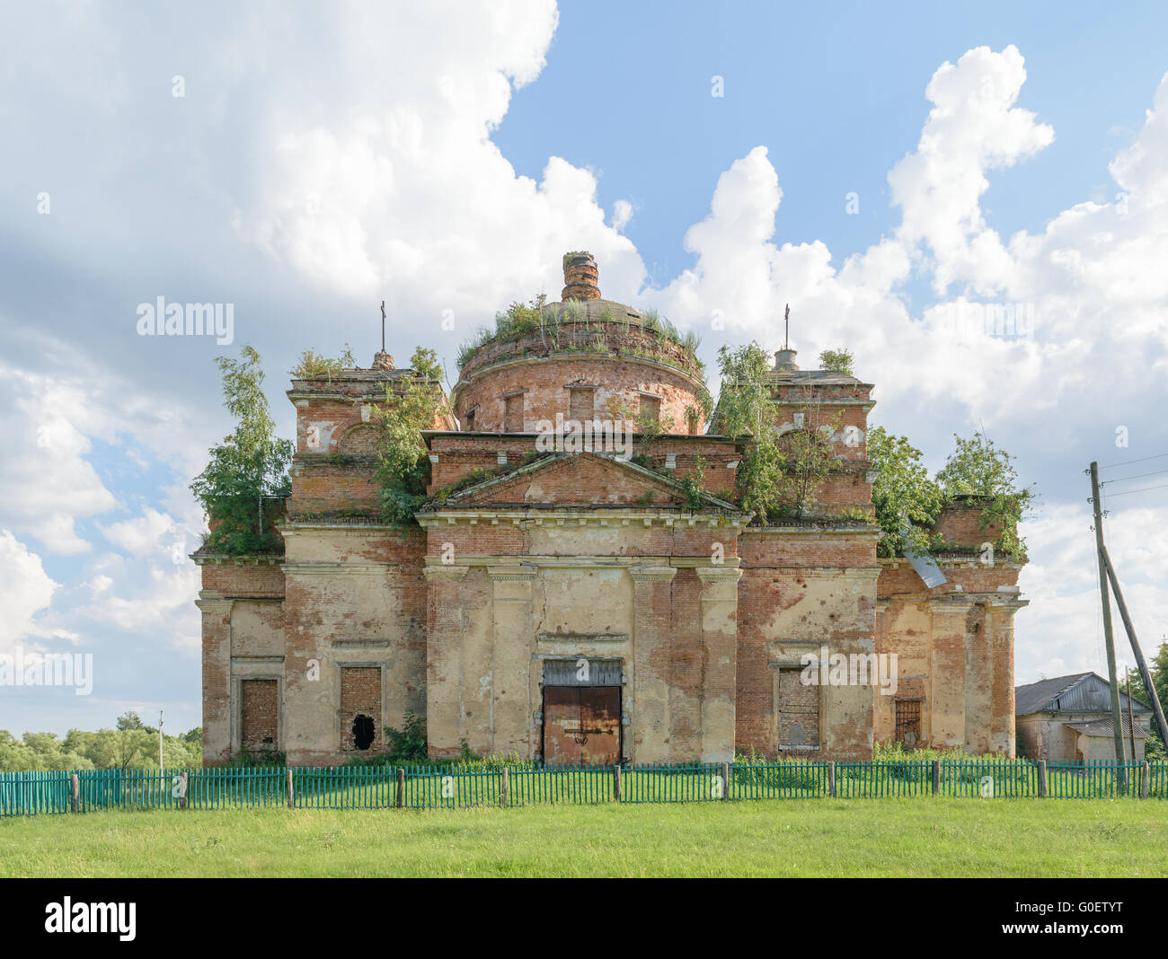 Overgrown temple in the village Stock Photo - Alamy