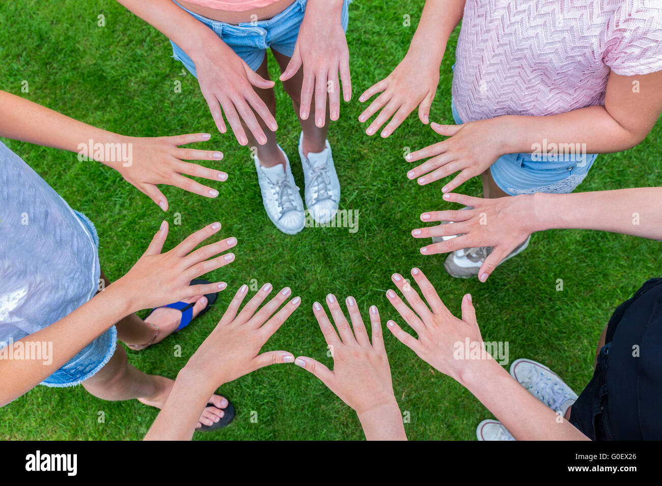 Children joining hands grass hi-res stock photography and images - Alamy