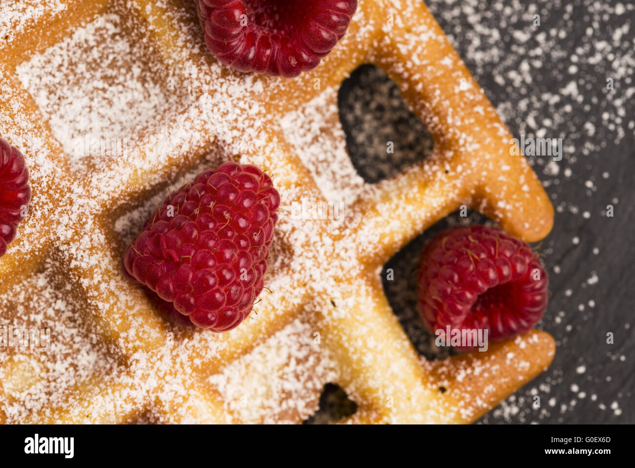 fresh waffles garnished with powdered sugar and raspberries Stock Photo ...