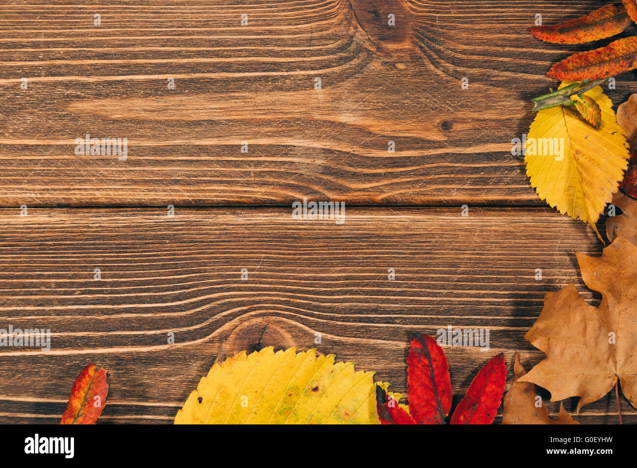 Background with wooden table and autumnal leaves Stock Photo - Alamy