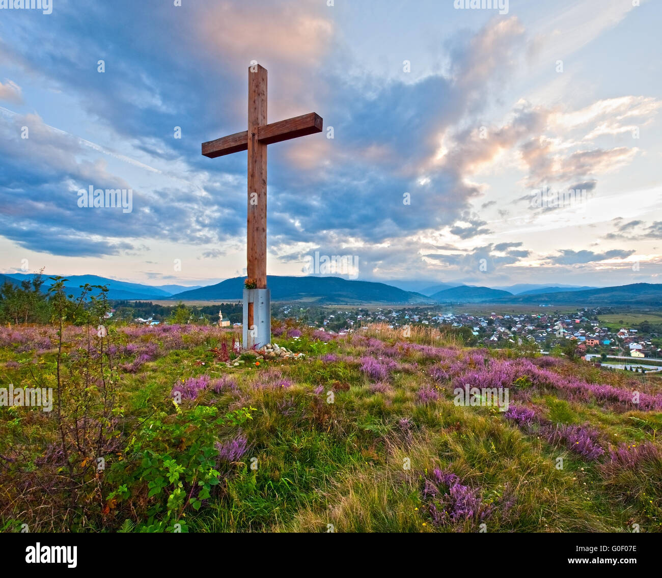 Summer evening country view with wooden cross Stock Photo - Alamy