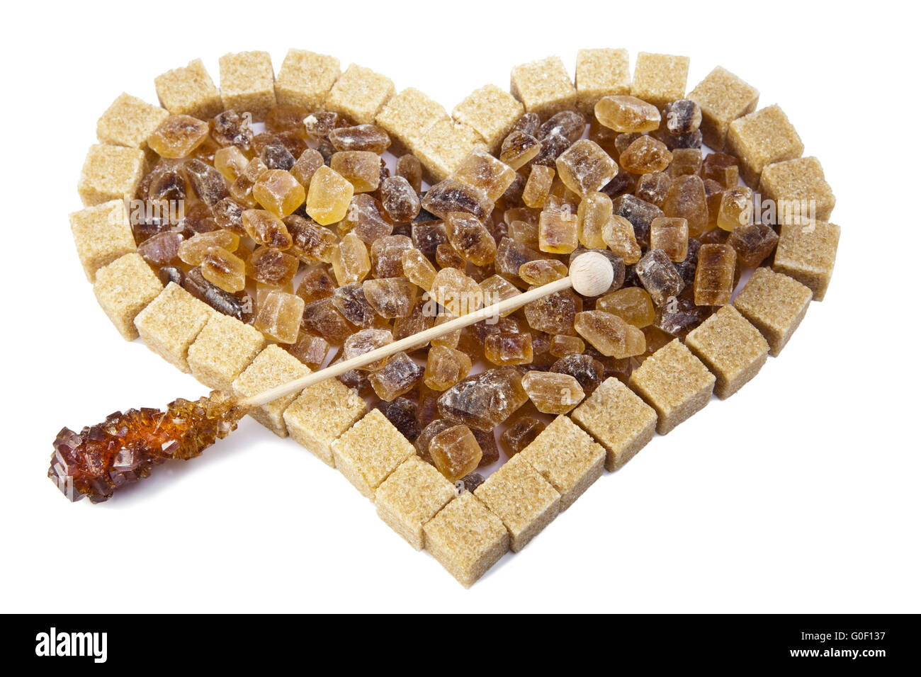 Heart from not refined reed sugar and candy sugar Stock Photo - Alamy