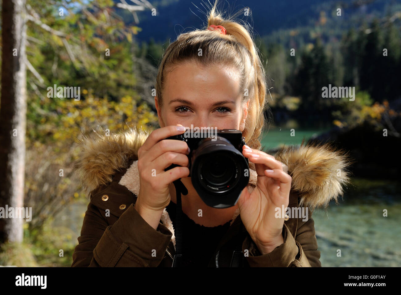 Young woman taking pictures Stock Photo - Alamy