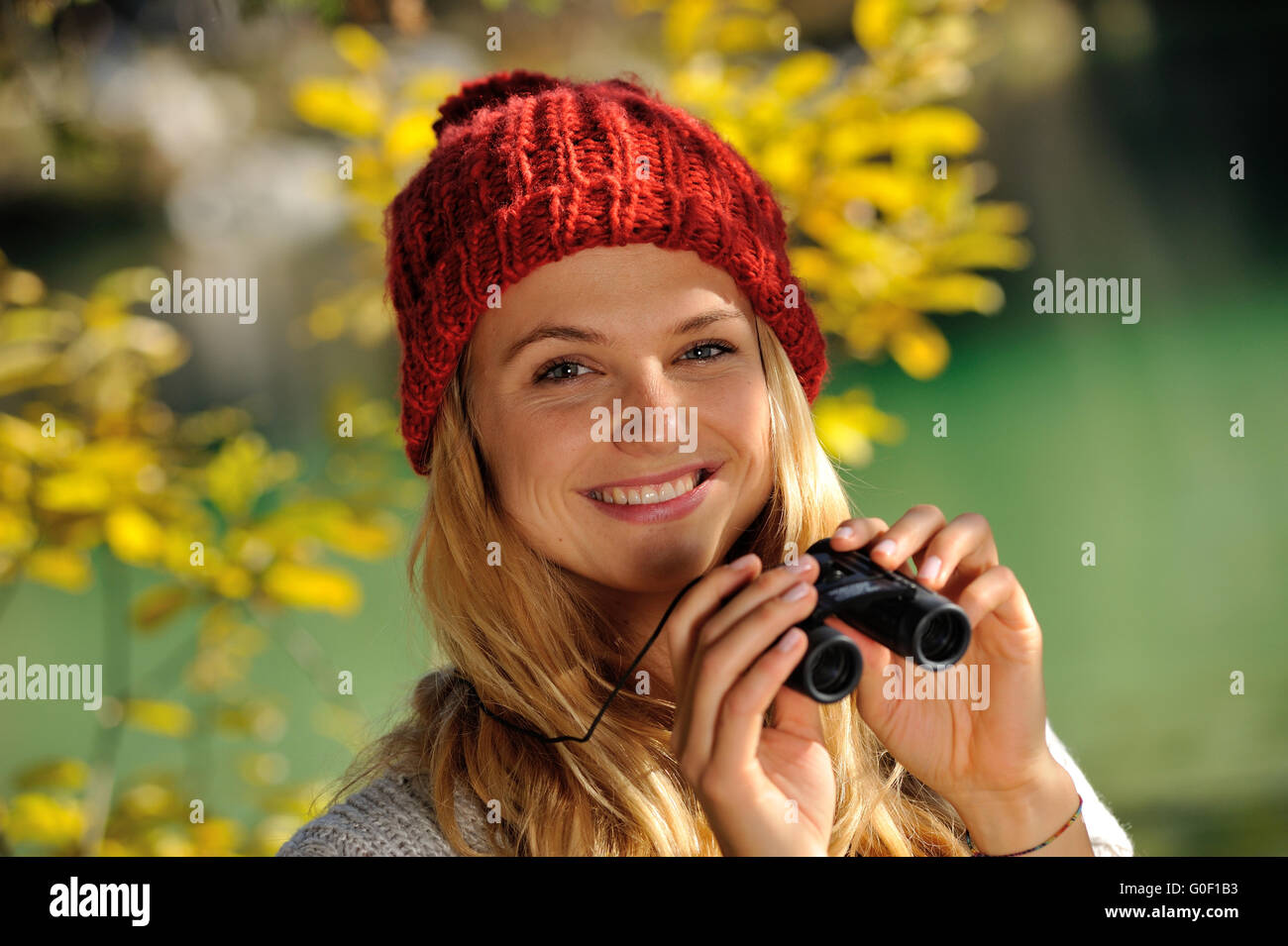 Young woman with binoculars Stock Photo - Alamy