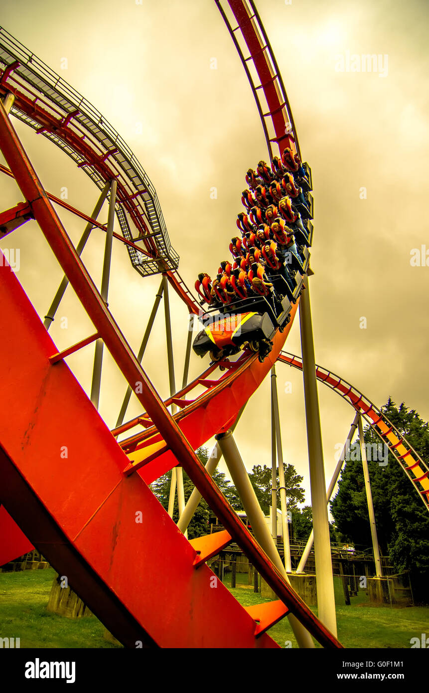 crazy rollercoaster rides at amusement park Stock Photo - Alamy