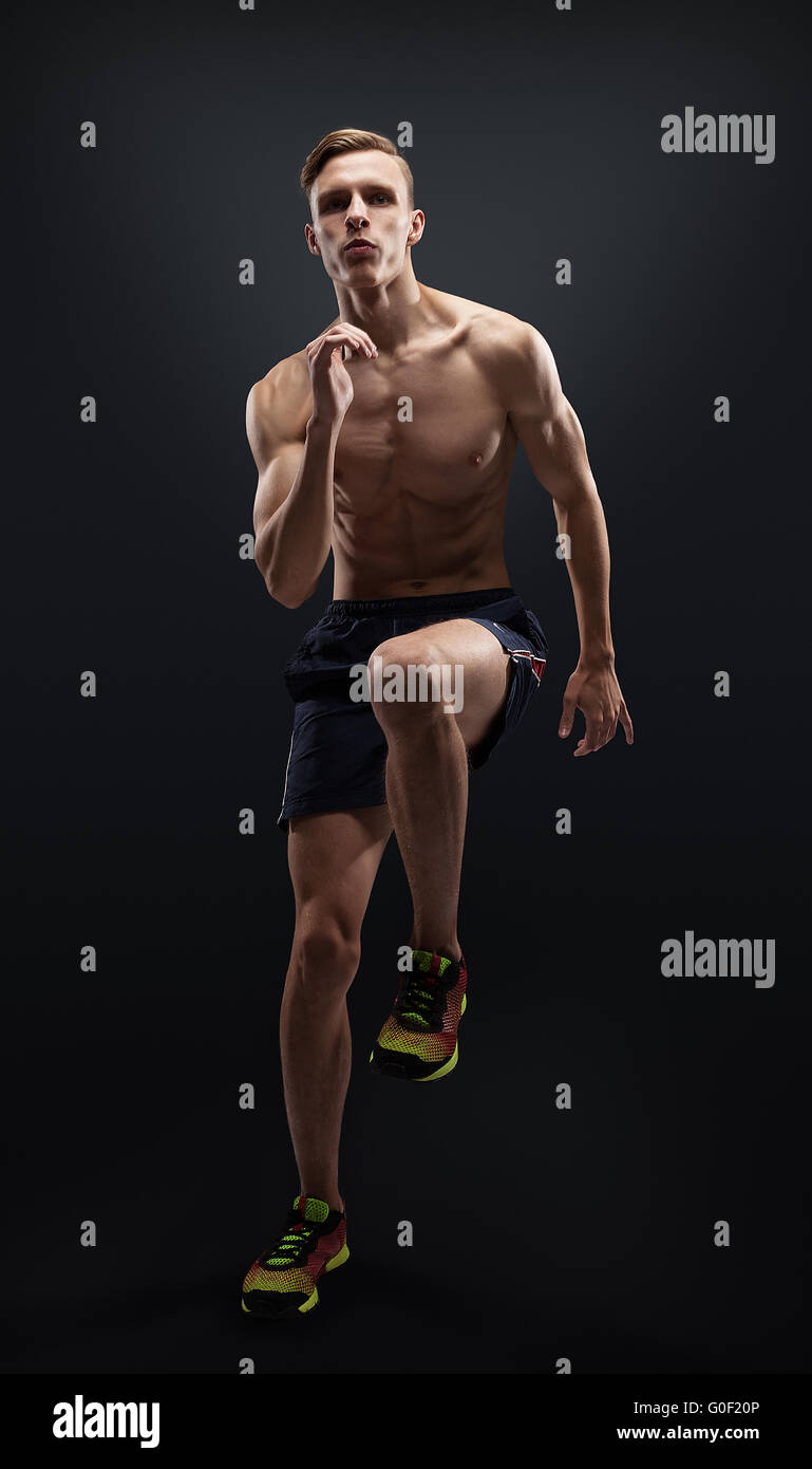 Healthy and fitness man running on black background Stock Photo - Alamy