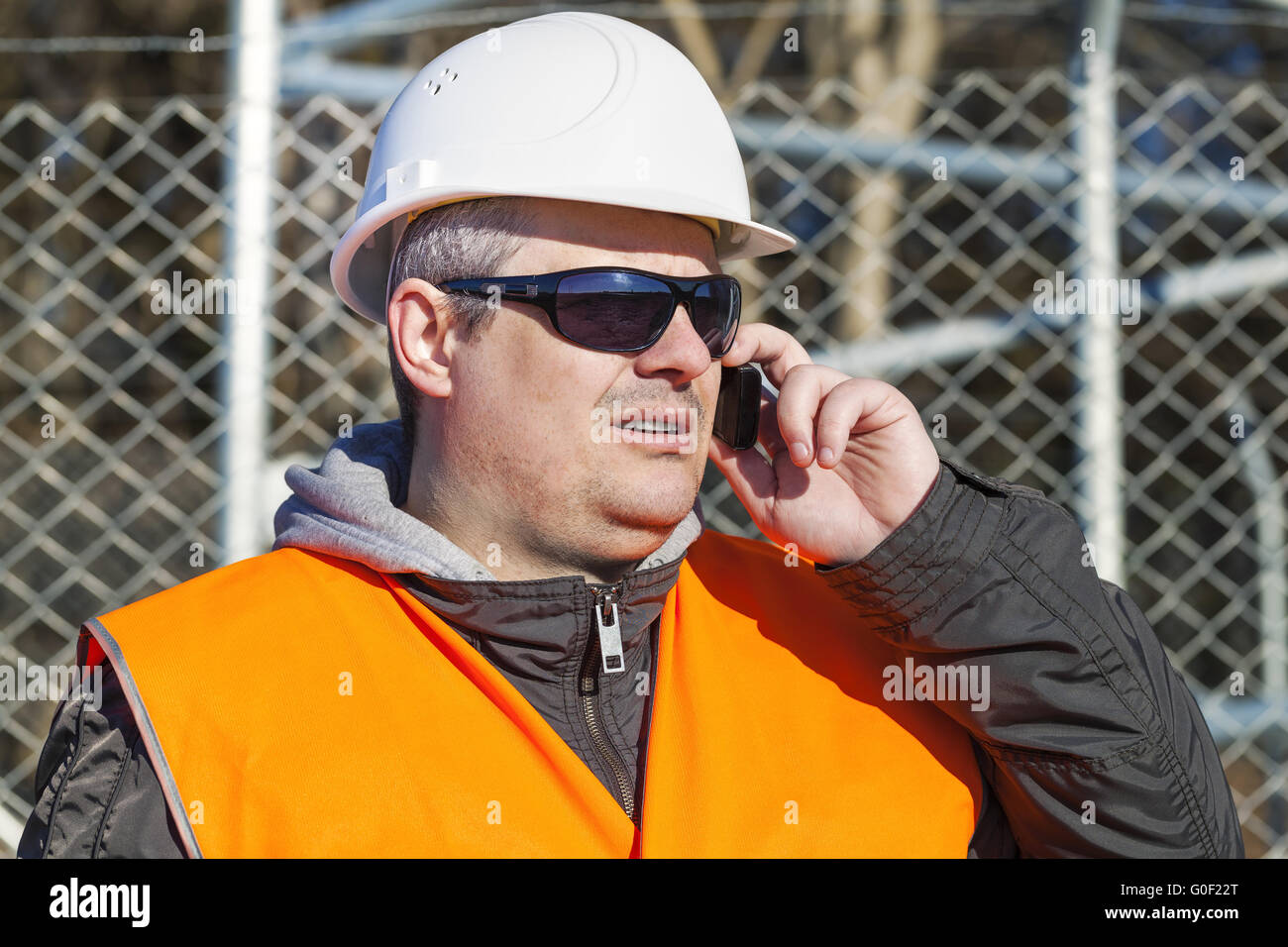 Engineer with the cell phone Stock Photo - Alamy