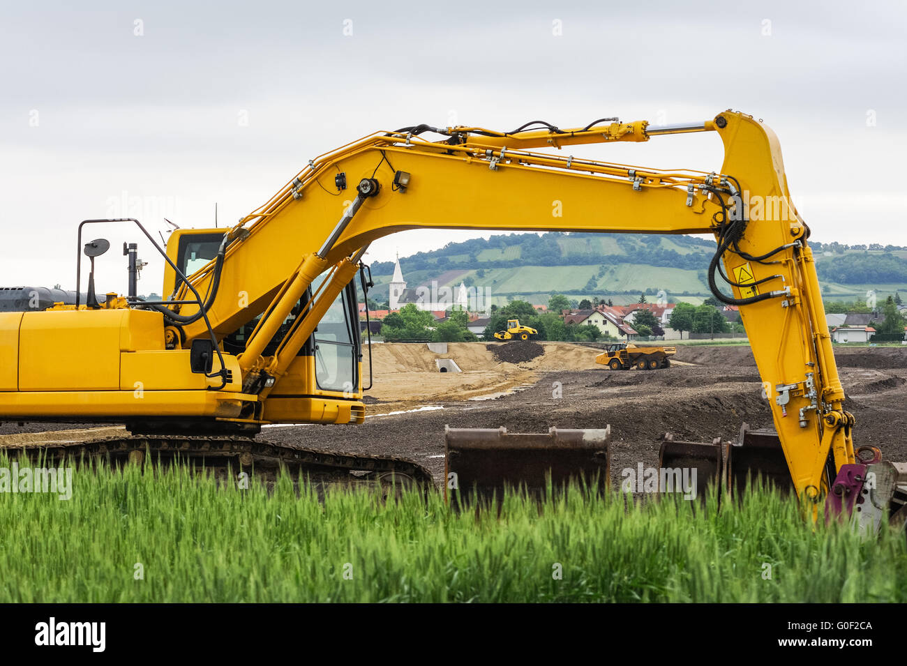 Excavators and other vehicles on construction site Stock Photo - Alamy