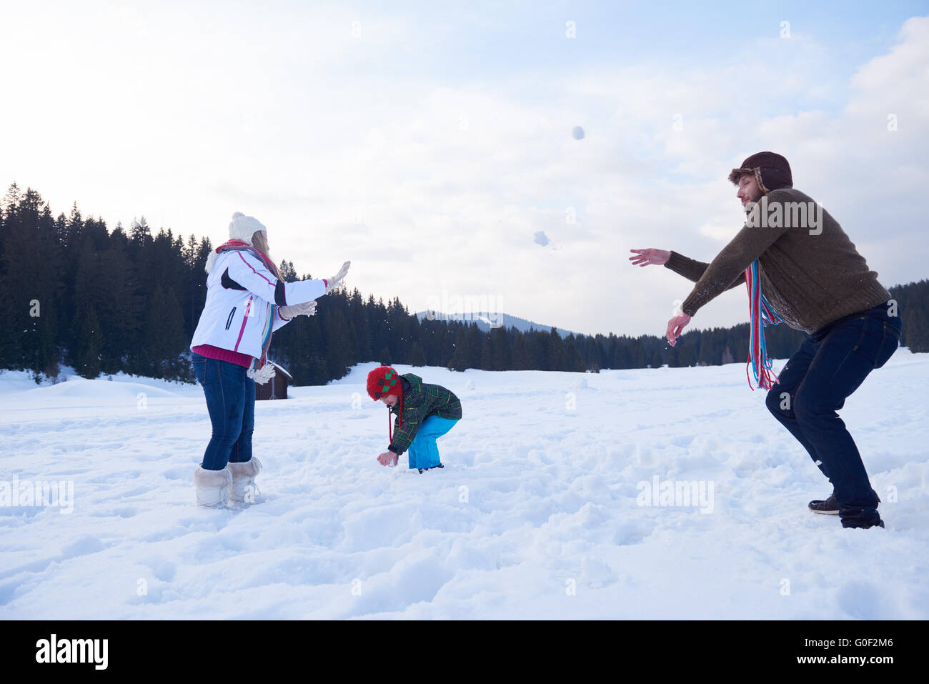 happy family playing together in snow at winter Stock Photo - Alamy