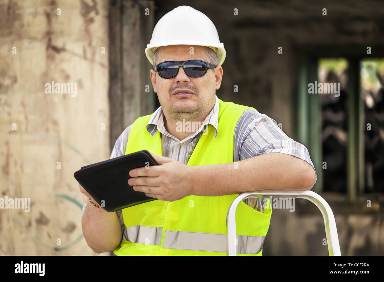 Building inspector with tablet near collapsed building Stock Photo - Alamy