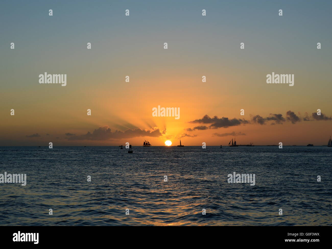 Sunset with palm trees at sand key beach hi-res stock photography and ...